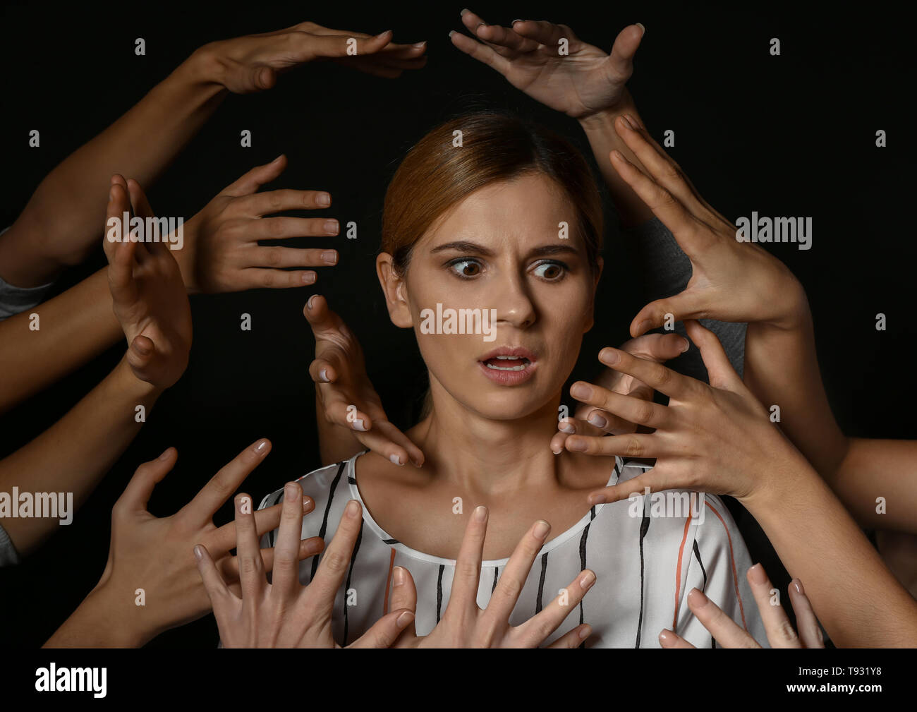 Many hands stretched to woman on dark background. Panic attack Stock ...