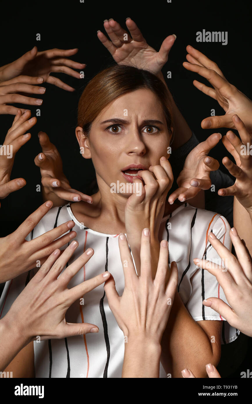 Many hands stretched to woman on dark background. Panic attack Stock ...