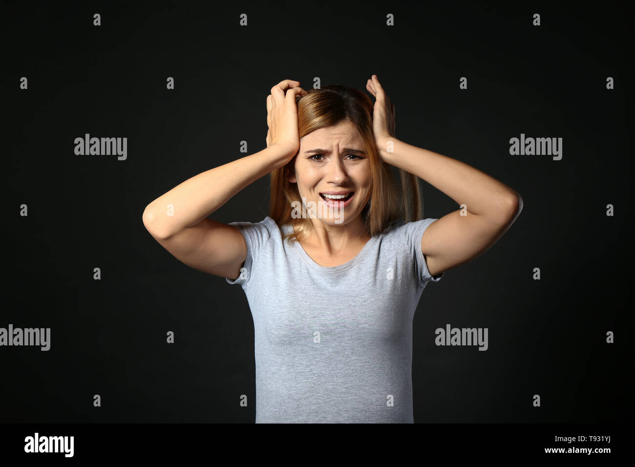 Woman having panic attack on dark background Stock Photo - Alamy