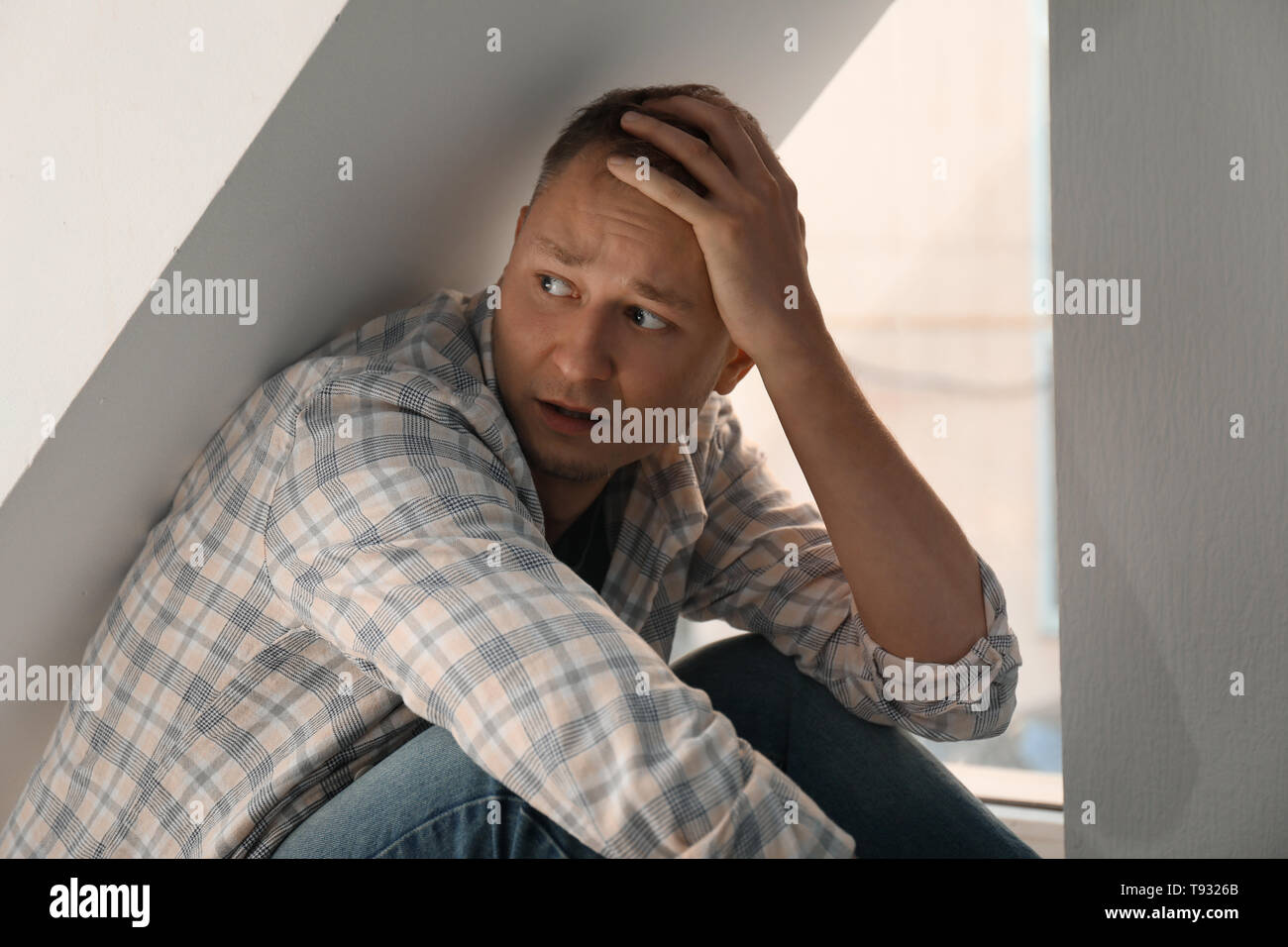 Man having panic attack indoors Stock Photo - Alamy
