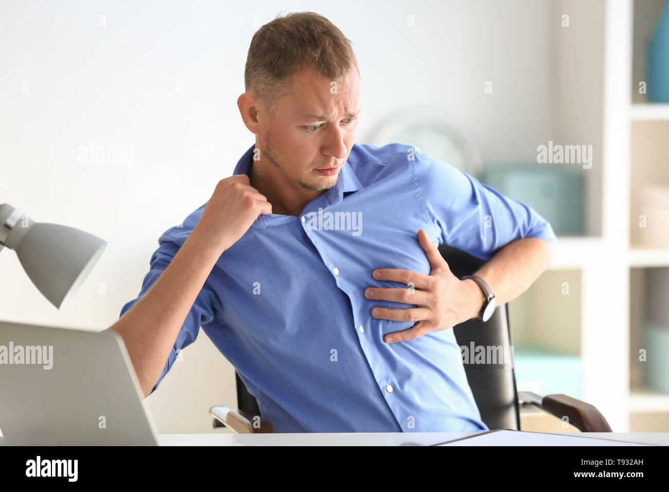 Man having panic attack at workplace in office Stock Photo - Alamy