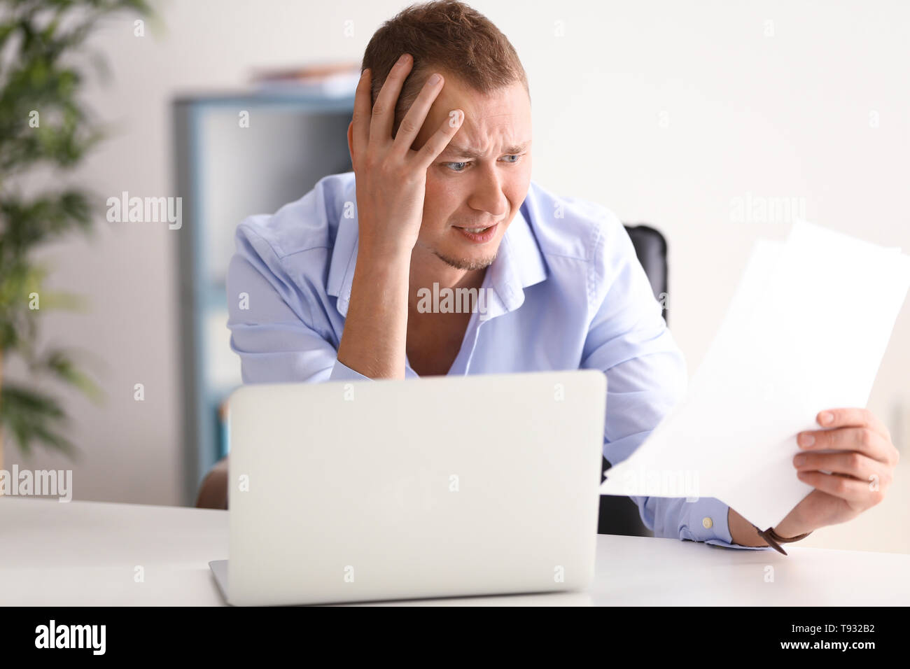 Man having panic attack at workplace in office Stock Photo - Alamy