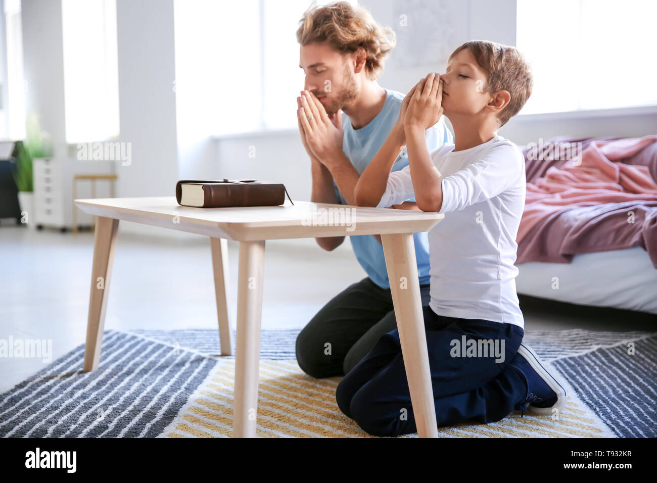 Father with son praying at home Stock Photo - Alamy