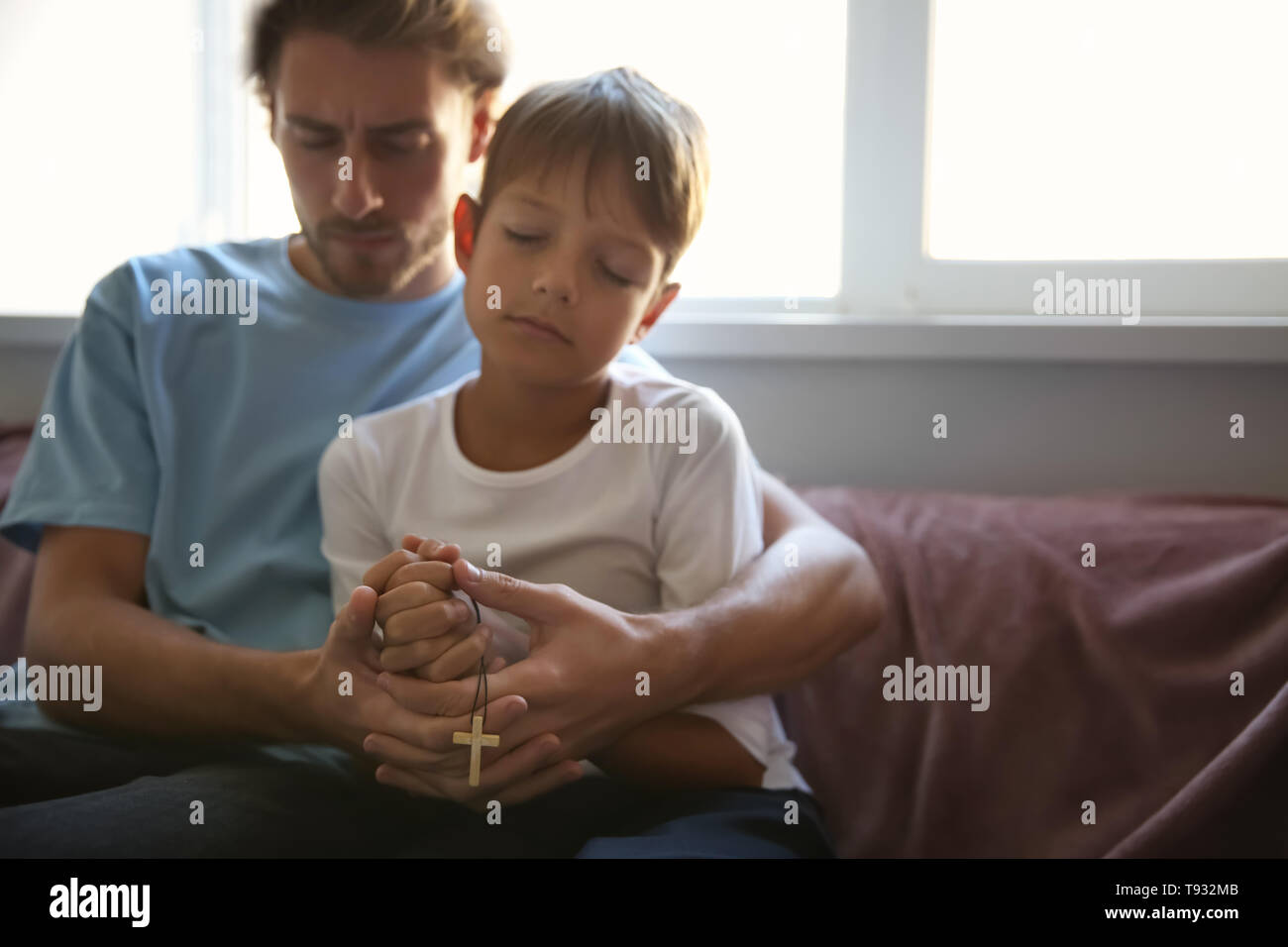 Father with son praying at home Stock Photo - Alamy