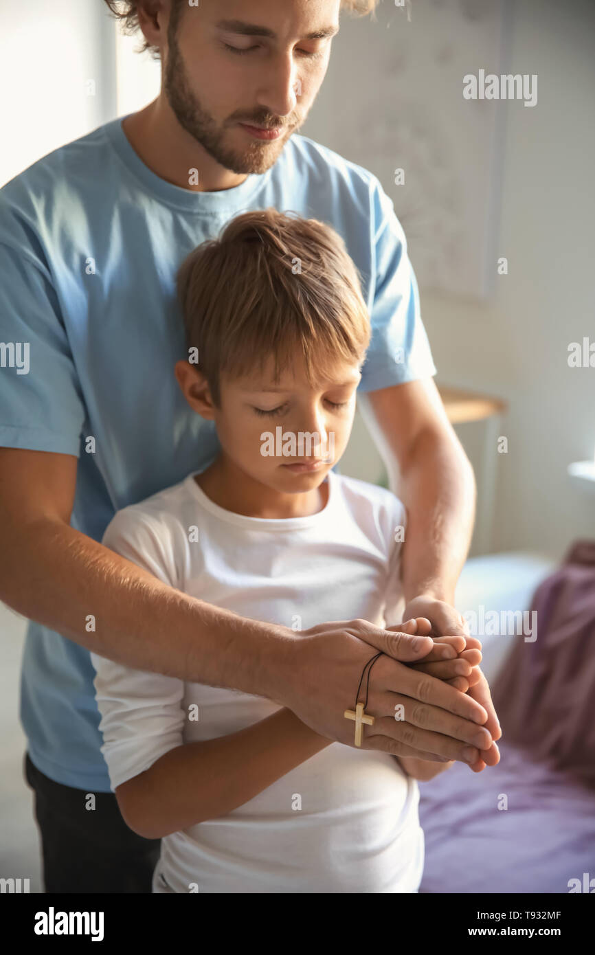 Father with son praying at home Stock Photo - Alamy