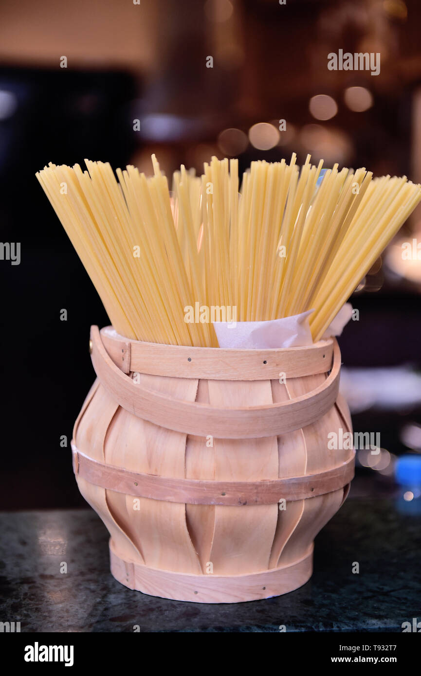 Spaghetti in a round wooden box Stock Photo - Alamy