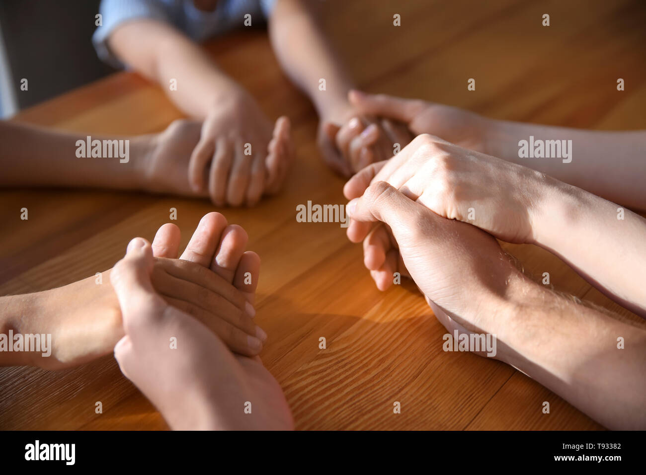 Young family praying sitting table hi-res stock photography and images ...