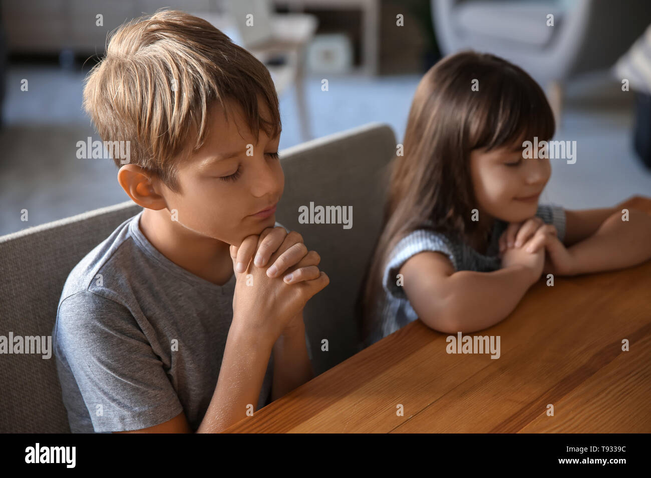 Cute children praying at home Stock Photo - Alamy