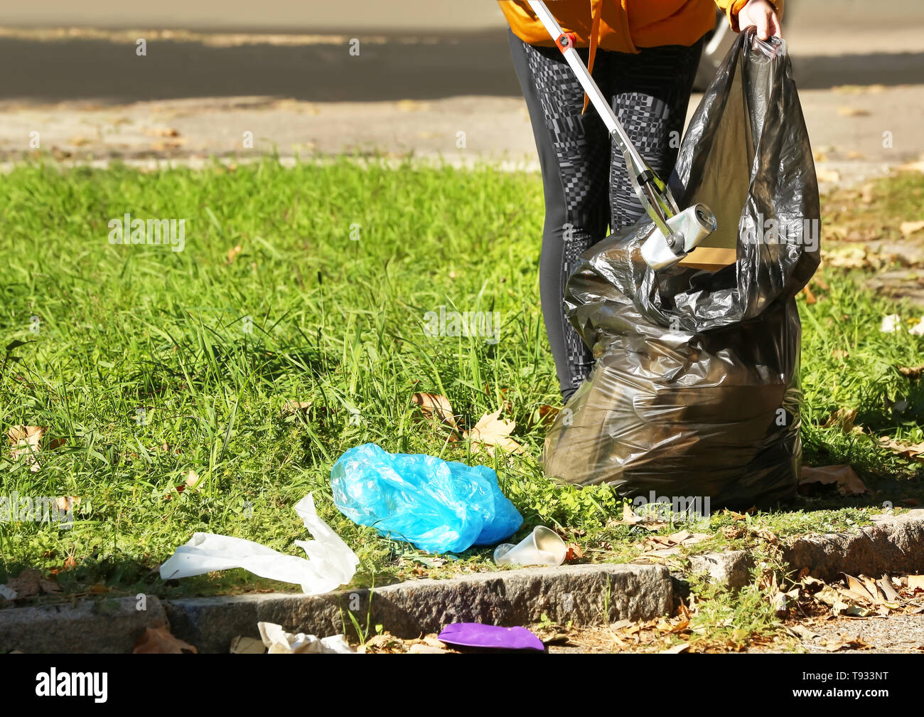 Put trash into trash can hi-res stock photography and images - Alamy