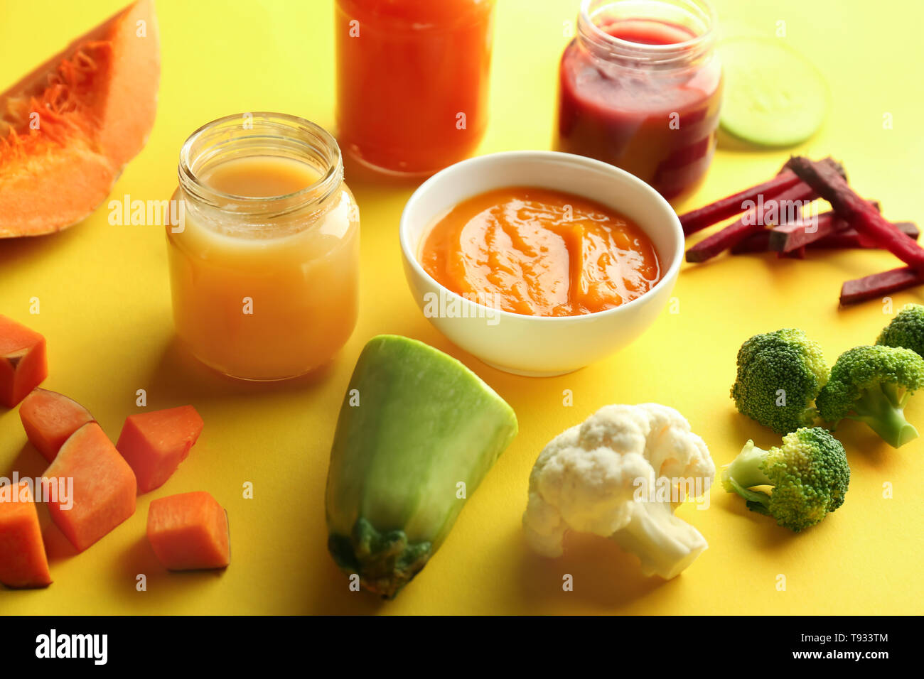 Healthy baby food and ingredients on color table Stock Photo - Alamy