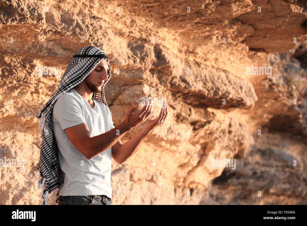 Young Muslim man praying outdoors Stock Photo - Alamy