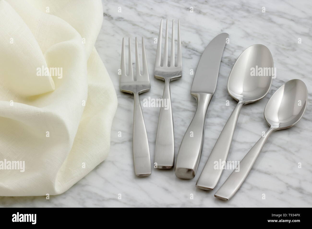 trendy and beautiful silverware set styled on linen double hemstitch ...
