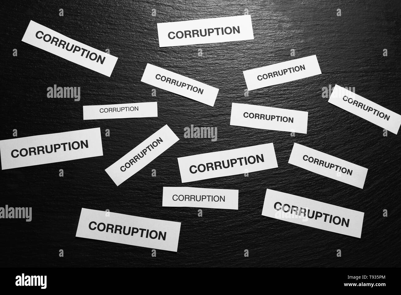 Pieces of paper with words CORRUPTION on black background Stock Photo ...