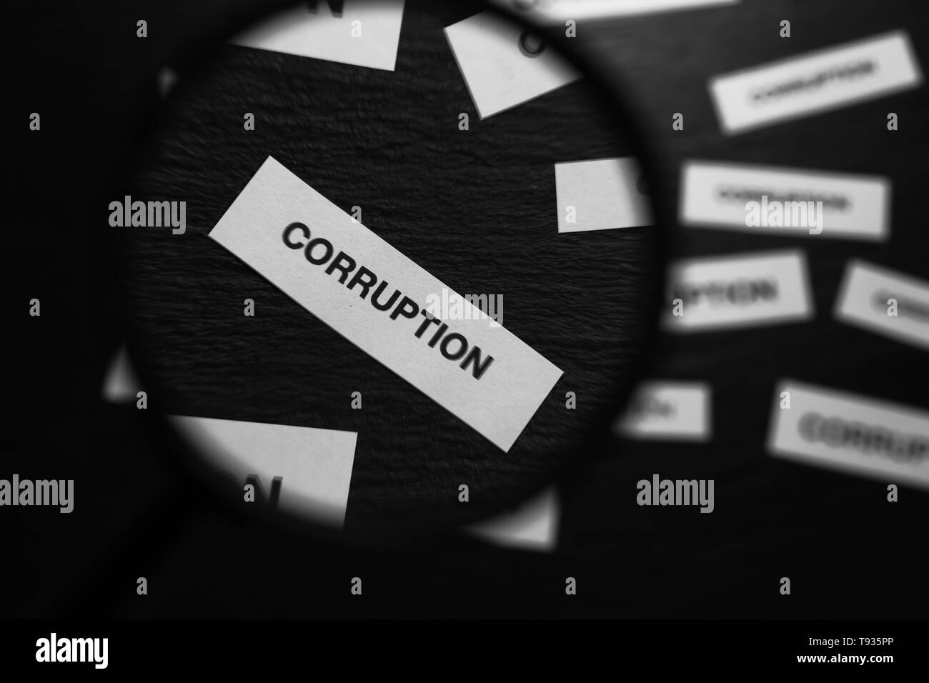 View on piece of paper with word CORRUPTION through magnifier glass on ...