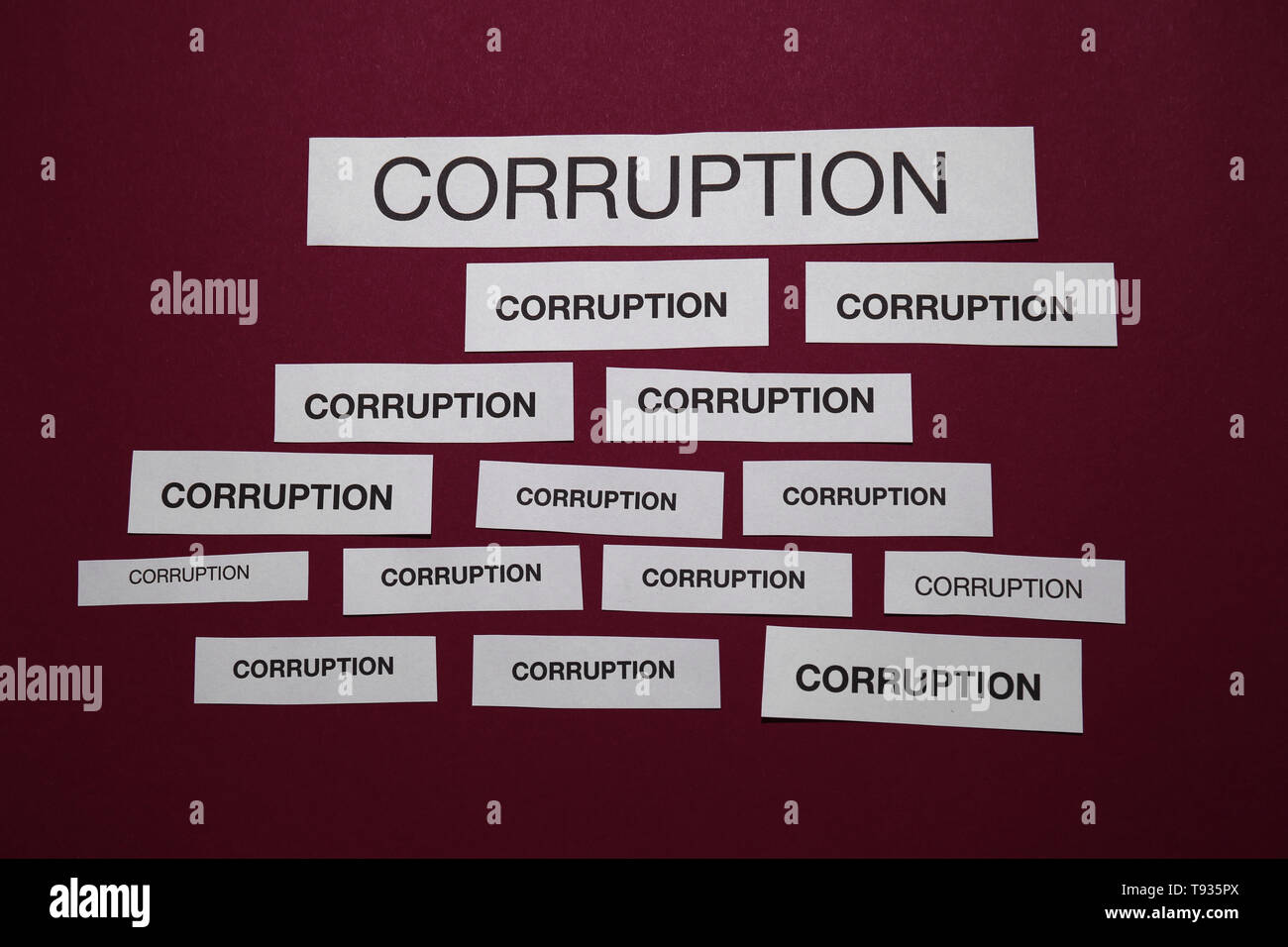 Pieces of paper with words CORRUPTION on red background Stock Photo - Alamy