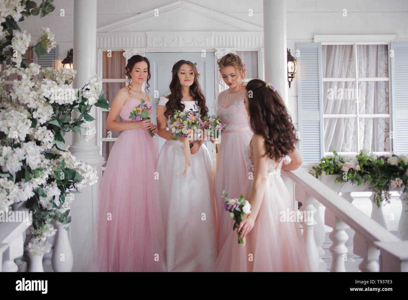 Happy girls at their best friend's wedding. Beautiful and elegant bride ...