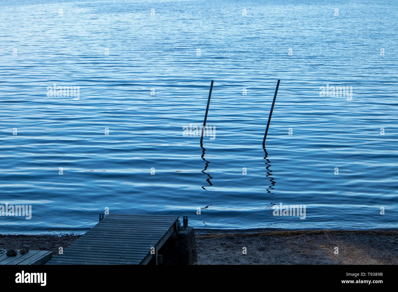 two poles in the water Stock Photo - Alamy