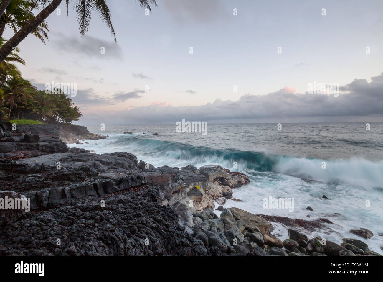 Amazing hawaiian beach. Wave in ocean at sunset or sunrise with surfer ...