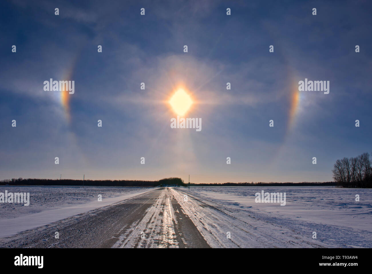 Sundogs and country road on prairie landscape Grande Pointe Manitoba ...