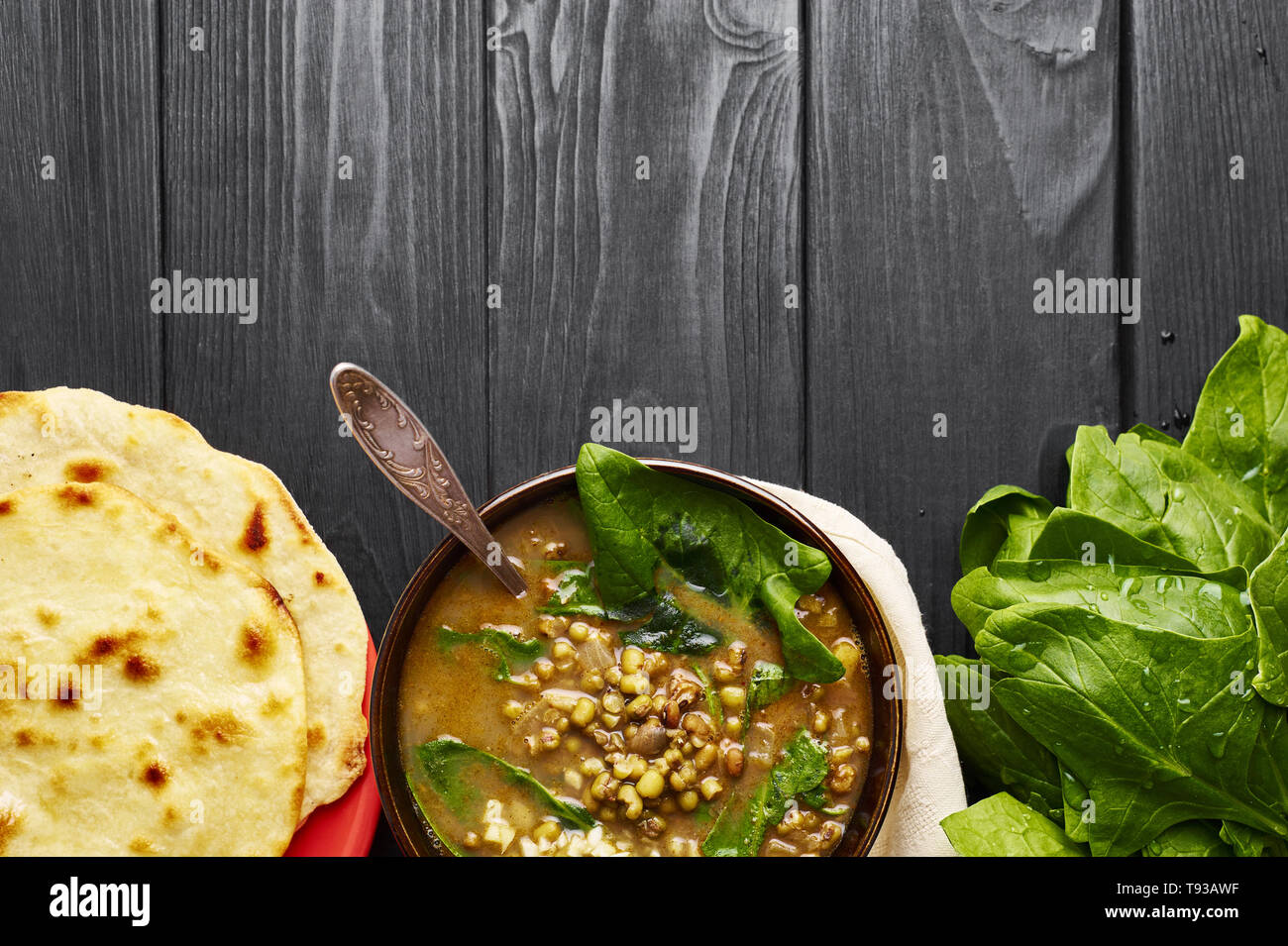 Mung Dhal with green Spinach and Chapati at black wooden tabletop ...
