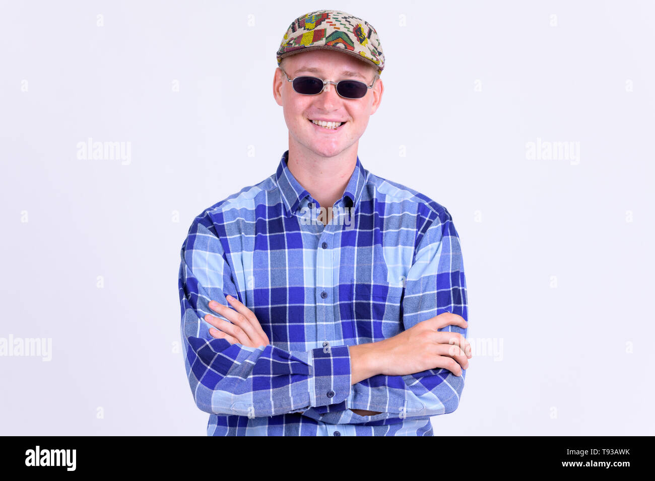 Happy young hipster man smiling with arms crossed Stock Photo - Alamy