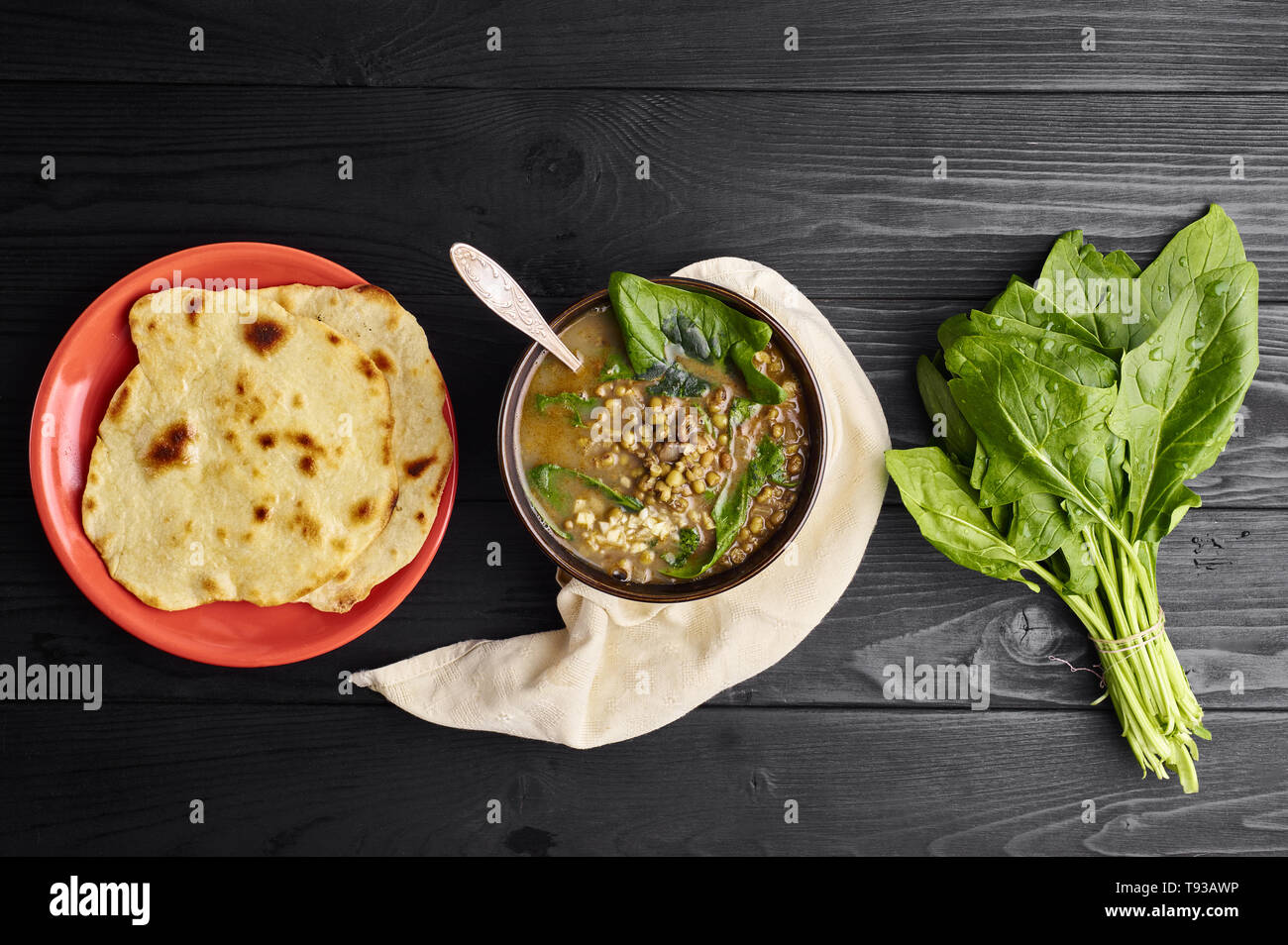 Mung Dhal with green Spinach and Chapati at black wooden tabletop ...