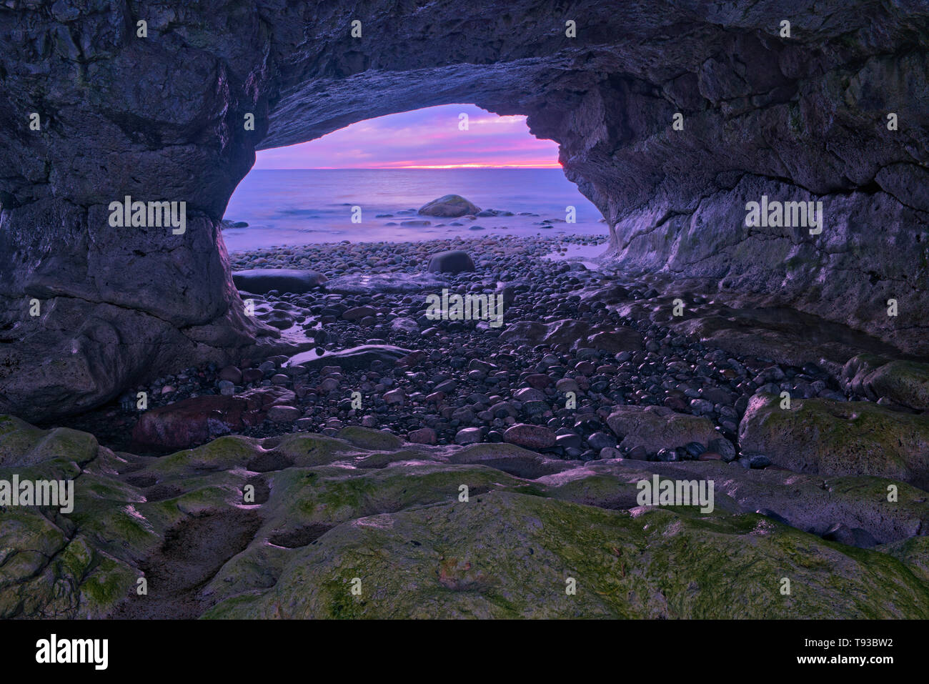 View of rocks along the Gulf of St. Lawrence at dusk as seen though the ...