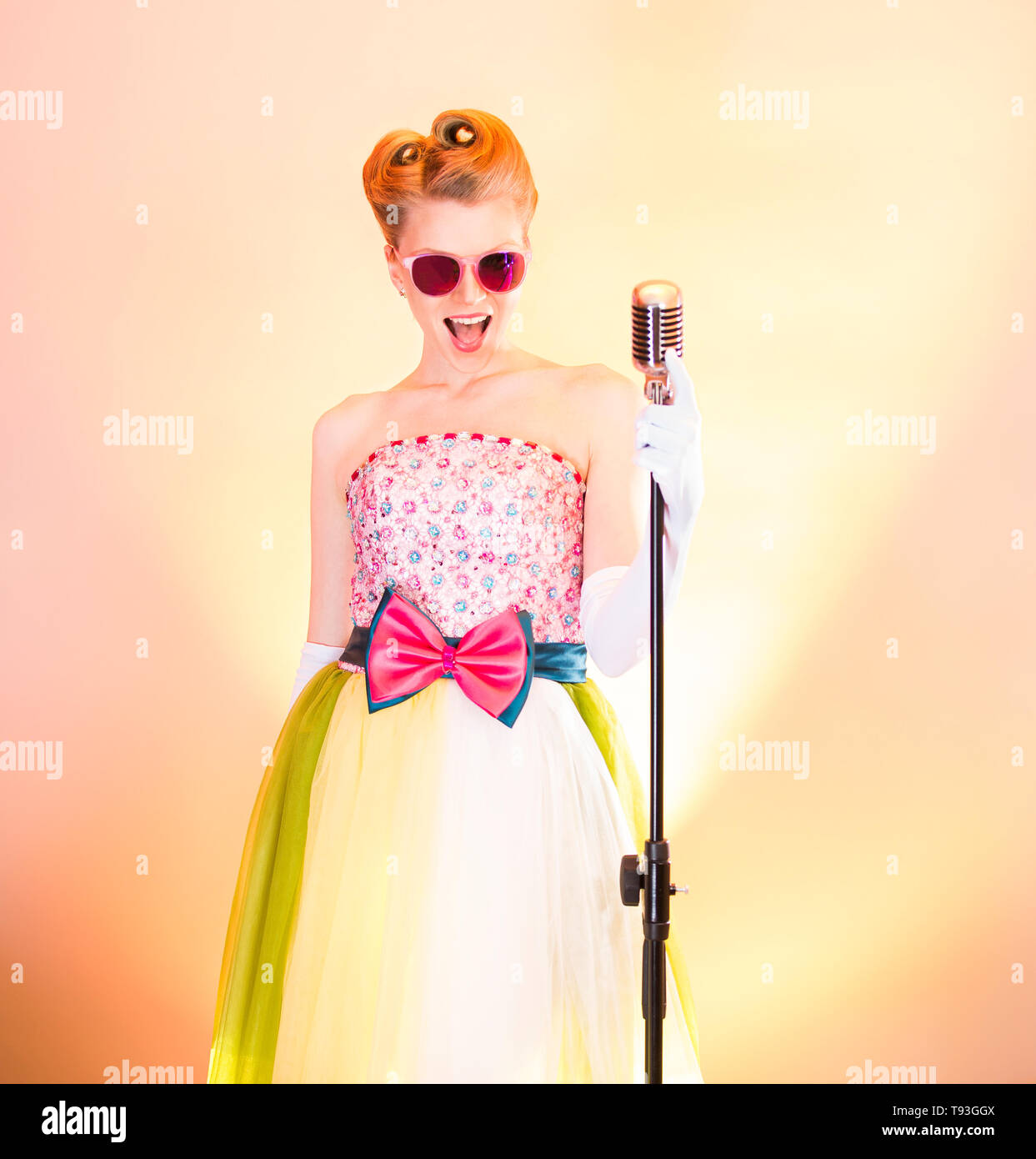 Happy girl singing in microphone hi-res stock photography and images ...