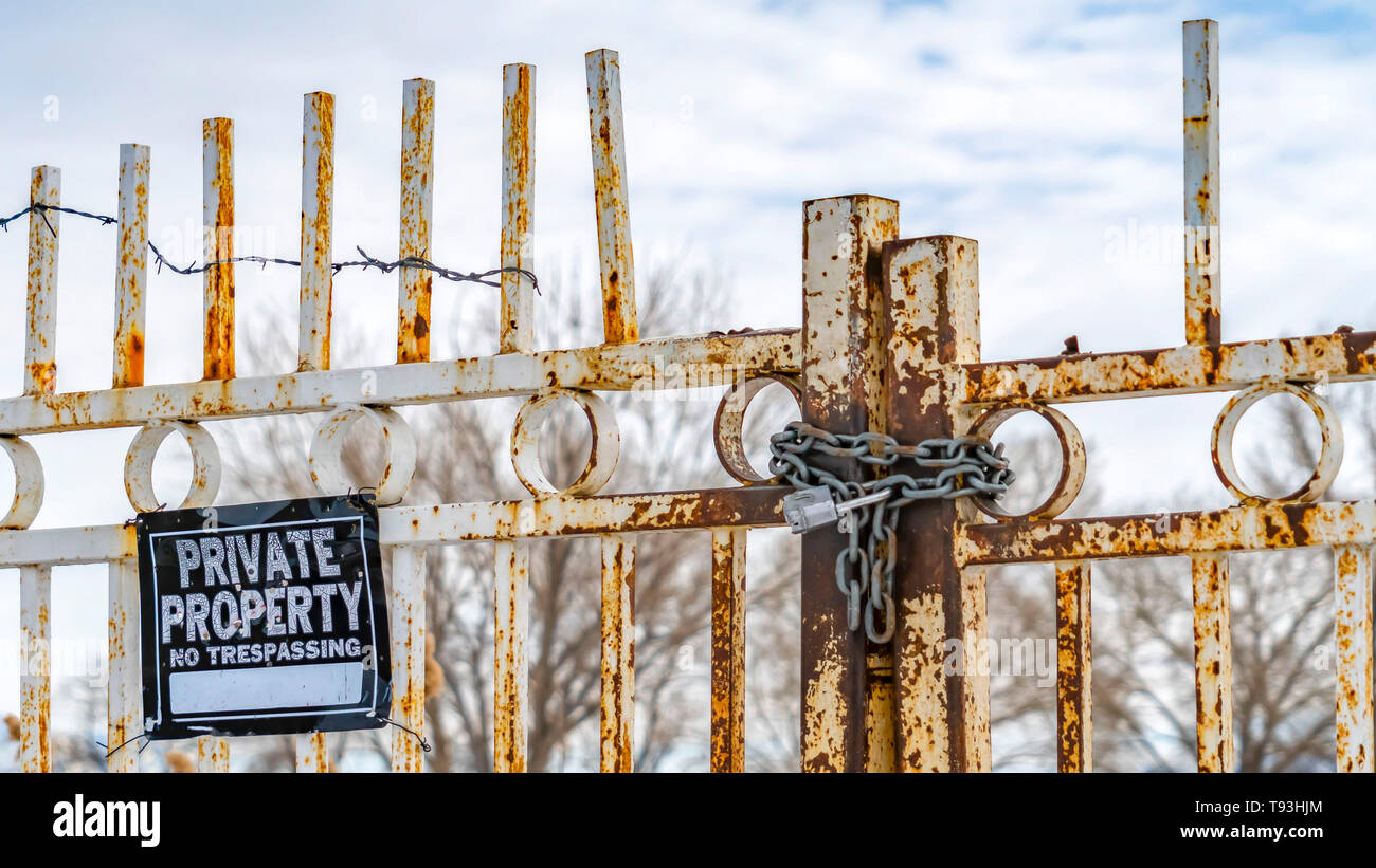Clear Panorama Private Property No Trespassing sign on a rusty gate ...