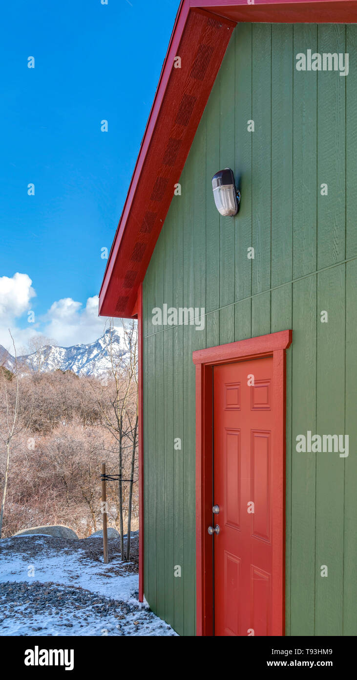 Clear Vertical Storage shed against trees and snow capped mountain ...