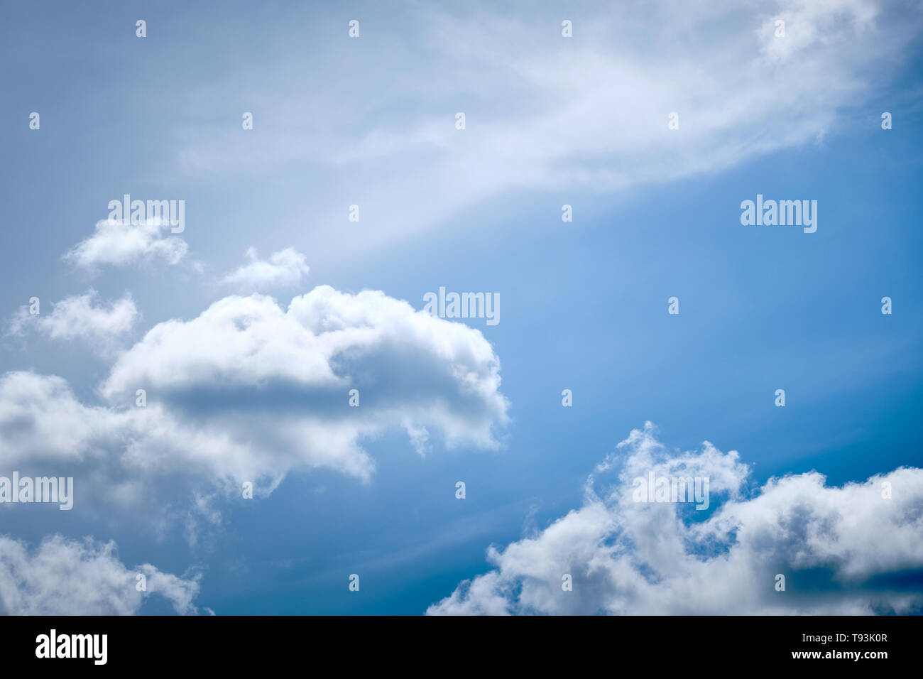 Beautiful bright and blue springtime sky with white clouds above ...