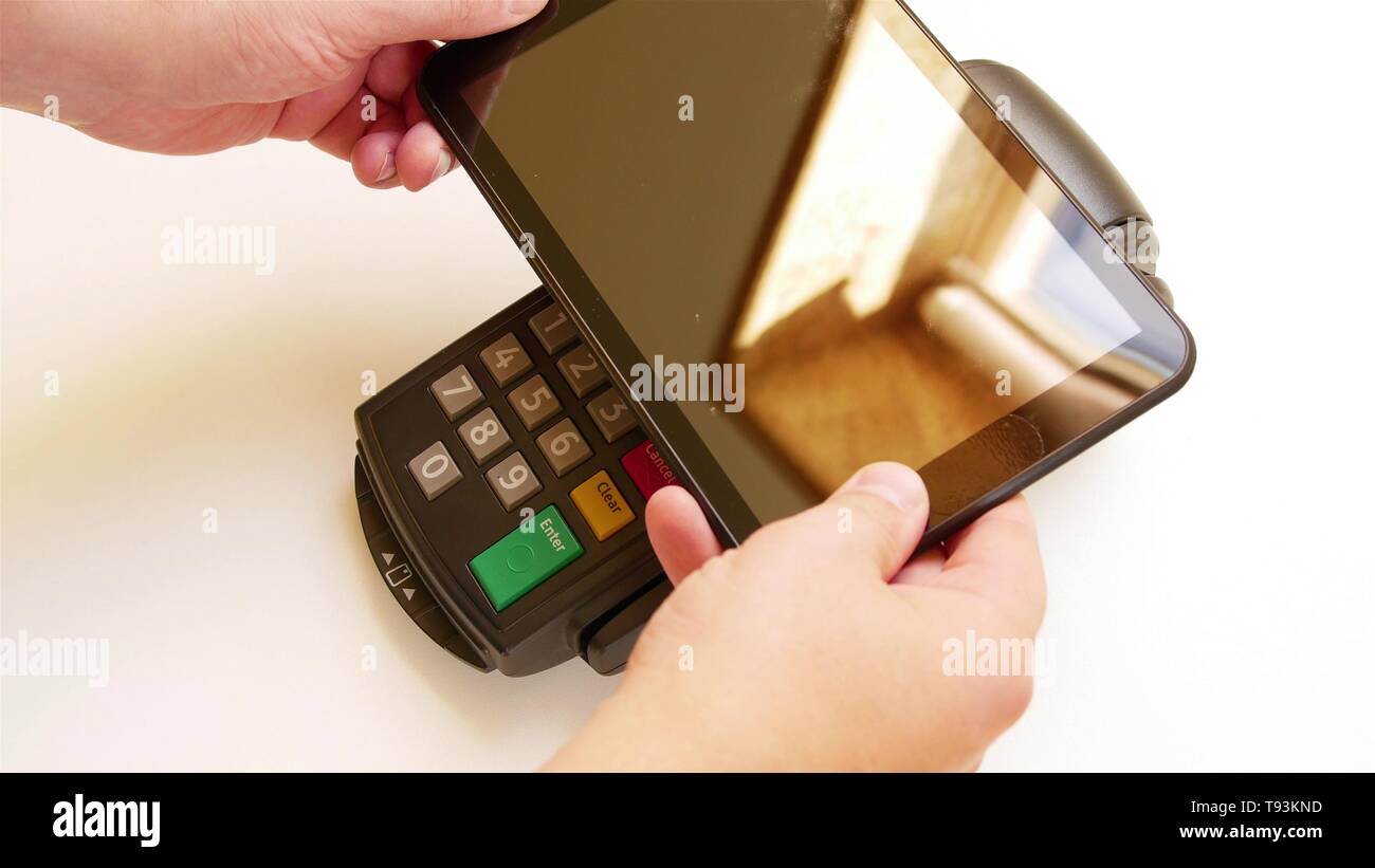 Paying with a tablet device wirelessly over credit card terminal Stock ...