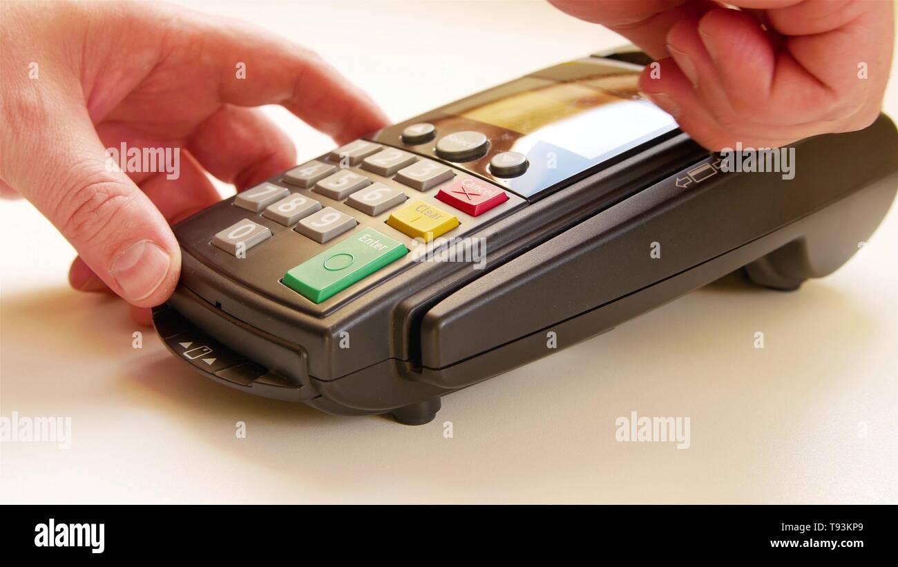 Payment terminal - a finger entering the PIN code Stock Photo - Alamy