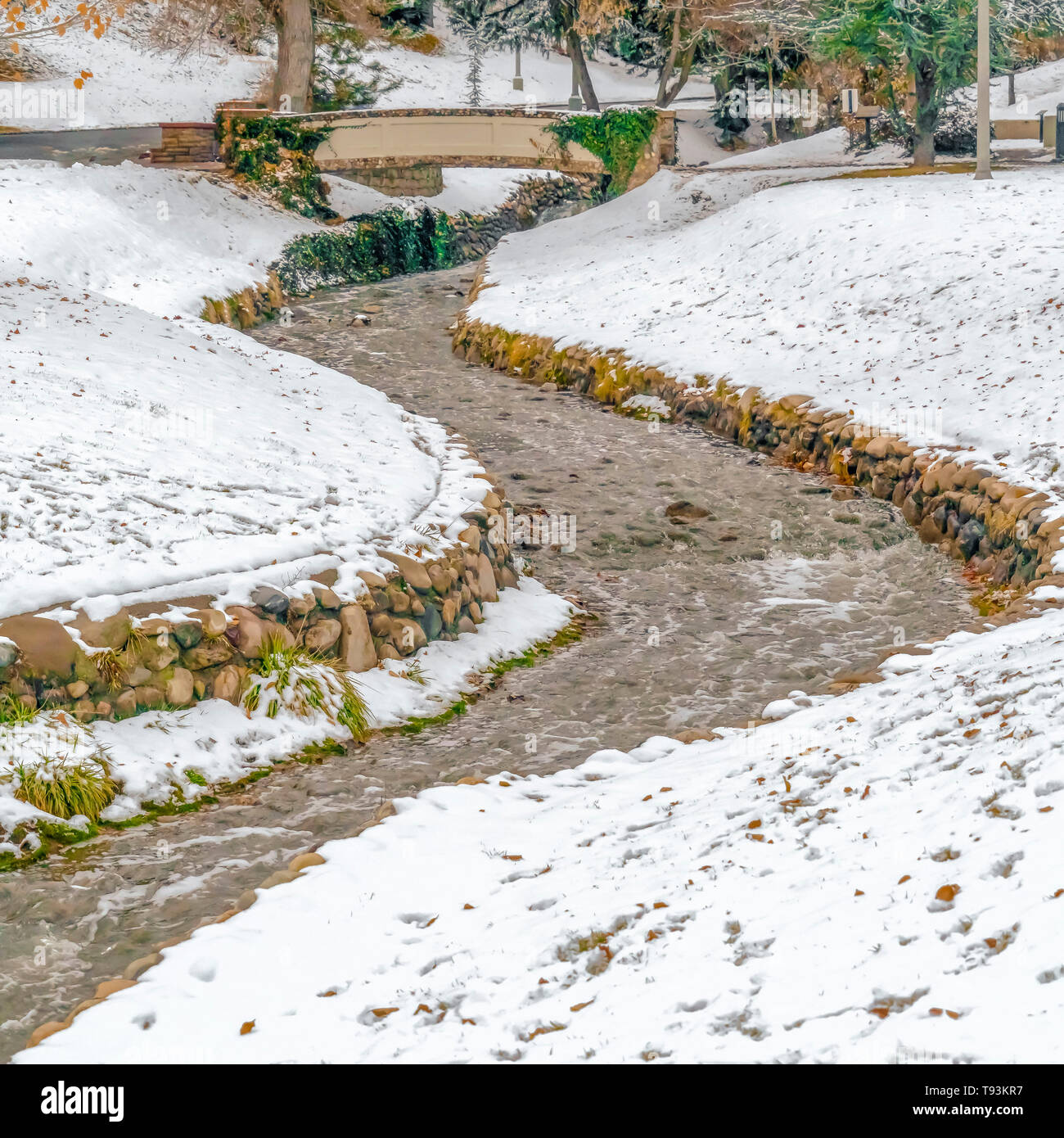 Clear Square Stone lined stream on a scenic and snowy park during ...
