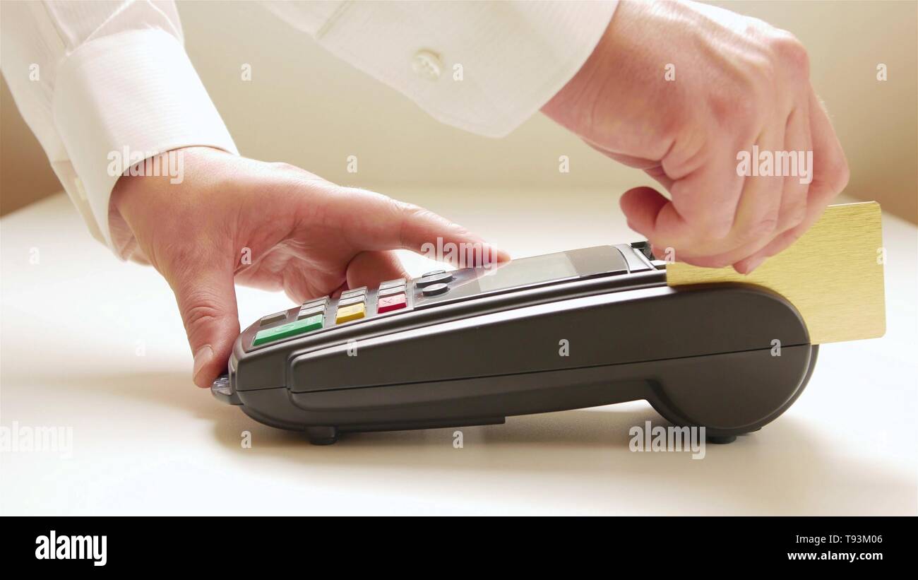 Hand Swiping Credit Card In Store. Female hands with credit card and ...