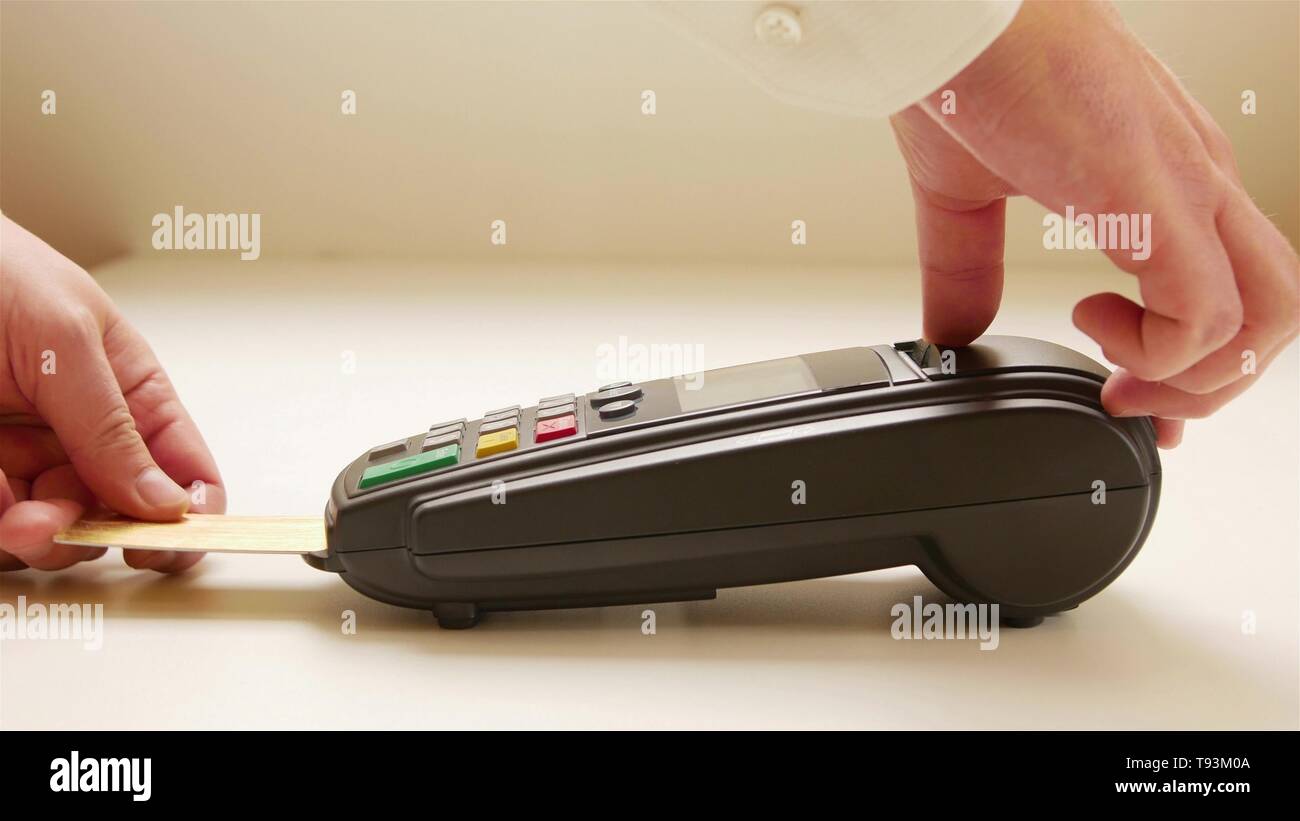 Hand Swiping Credit Card In Store. Female hands with credit card and ...