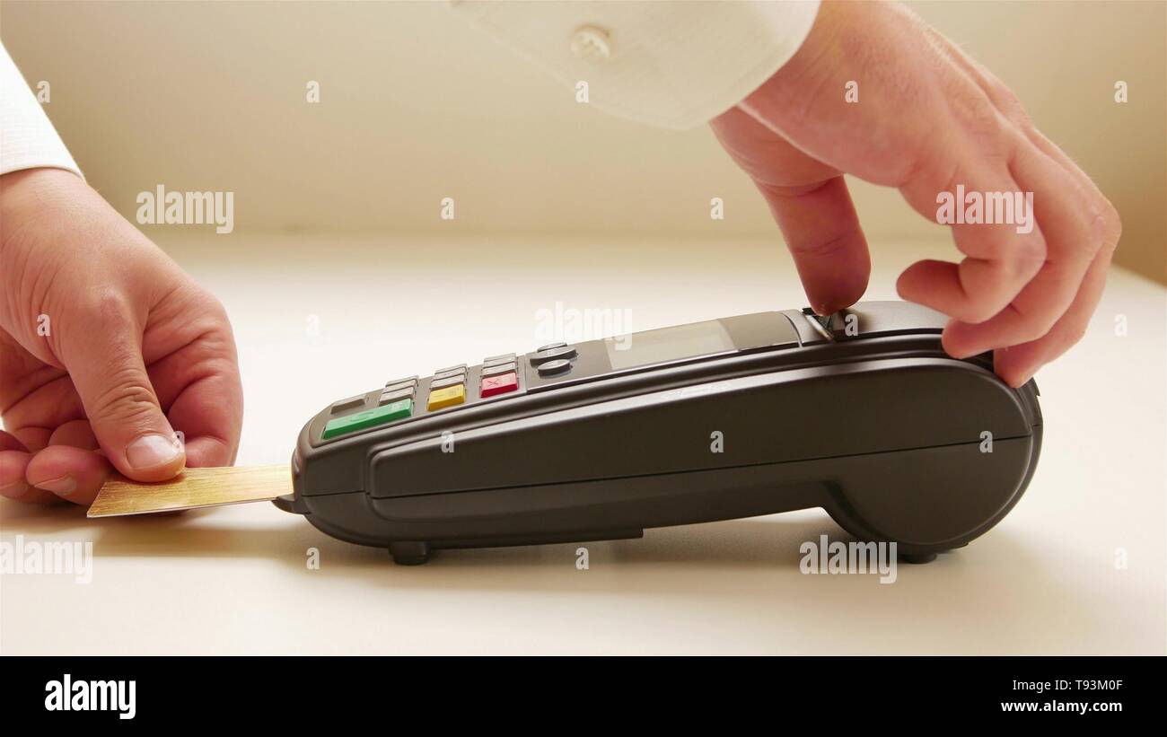 Hand Swiping Credit Card In Store. Female hands with credit card and ...