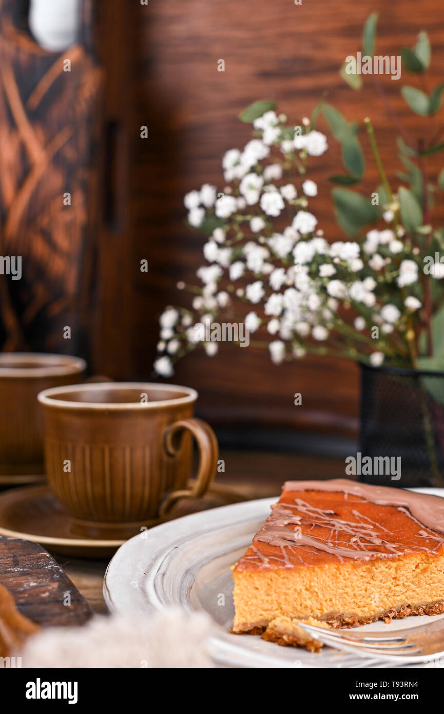 Cheesecake with chocolate and carrot puree. Vintage photo on wooden ...
