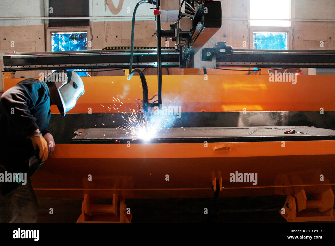 Worker and cnc machine Stock Photo - Alamy