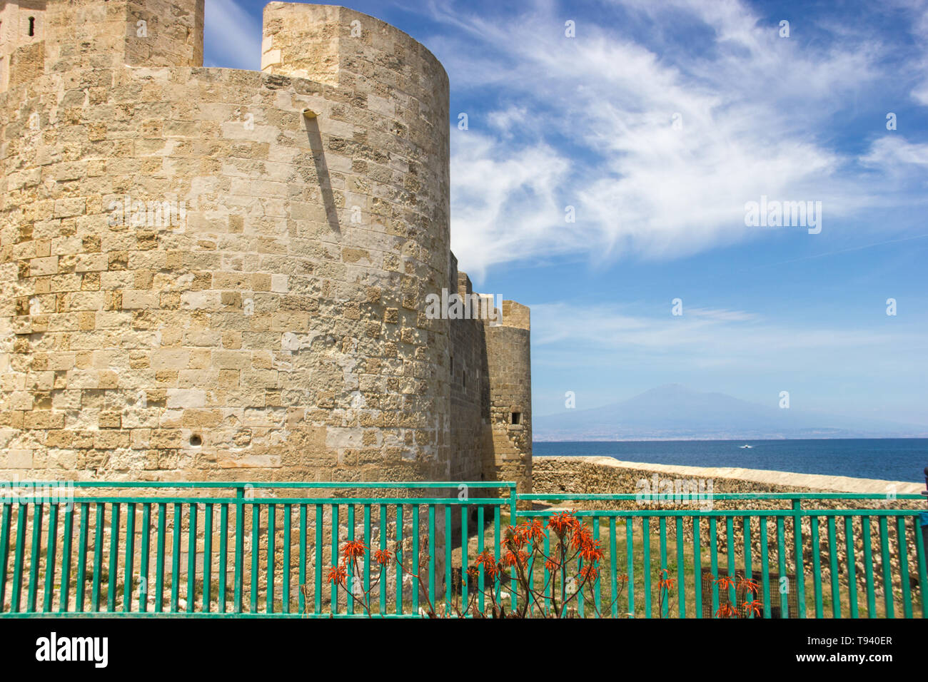 Brucoli castle detail of side tower with mount Etna far in the sea ...