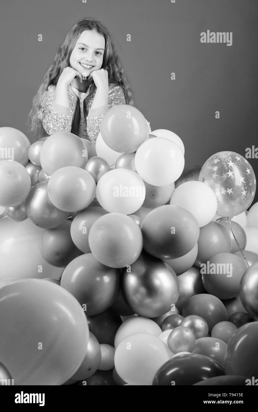 Having fun. Balloons theme party. Girl play with air balloons. Birthday ...