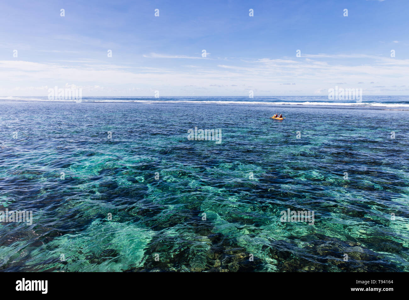 Family doing watersport kayak in clear pacific ocean water in the reef ...