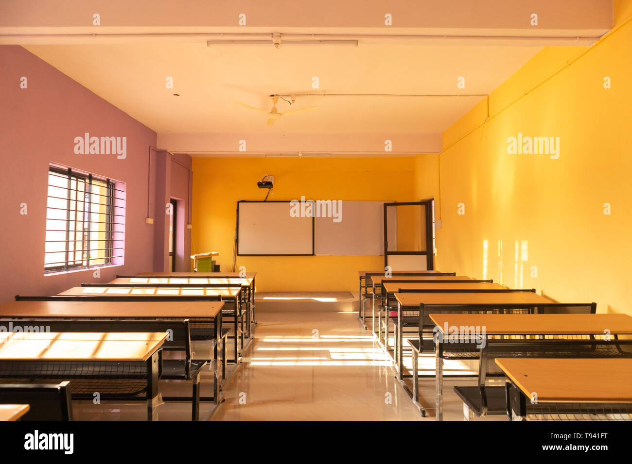 Empty class room and desks with colorful walls Stock Photo - Alamy