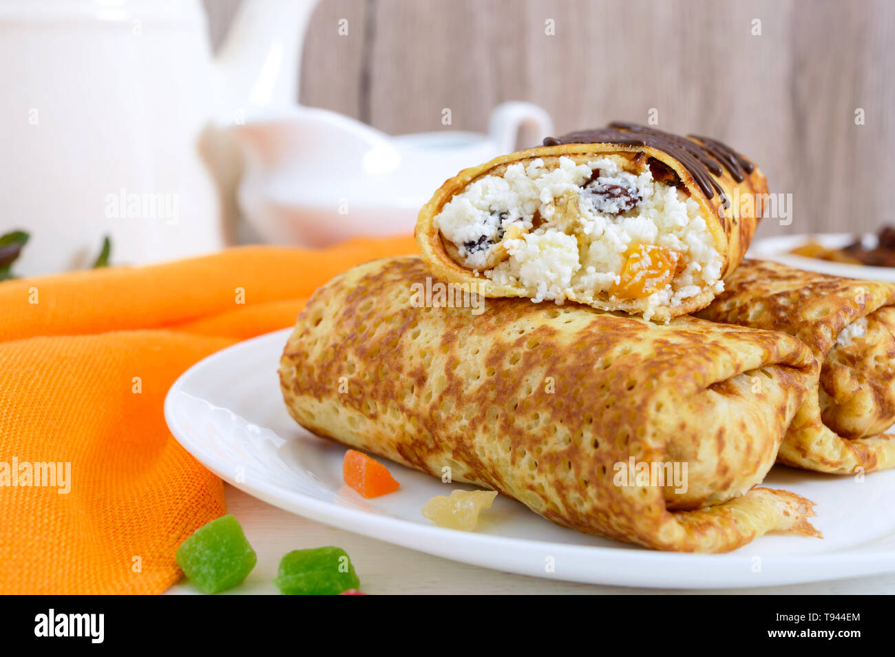 Delicious delicate pancakes with cottage cheese and raisins on a white ...