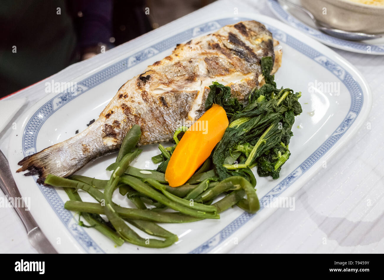 A plate of grilled fish with vegetable and carrot Stock Photo - Alamy