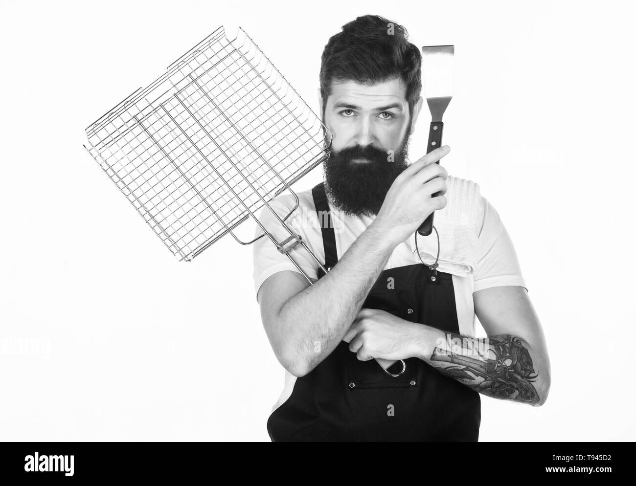 Bearded hipster wear apron for barbecue. Roasting and grilling food ...