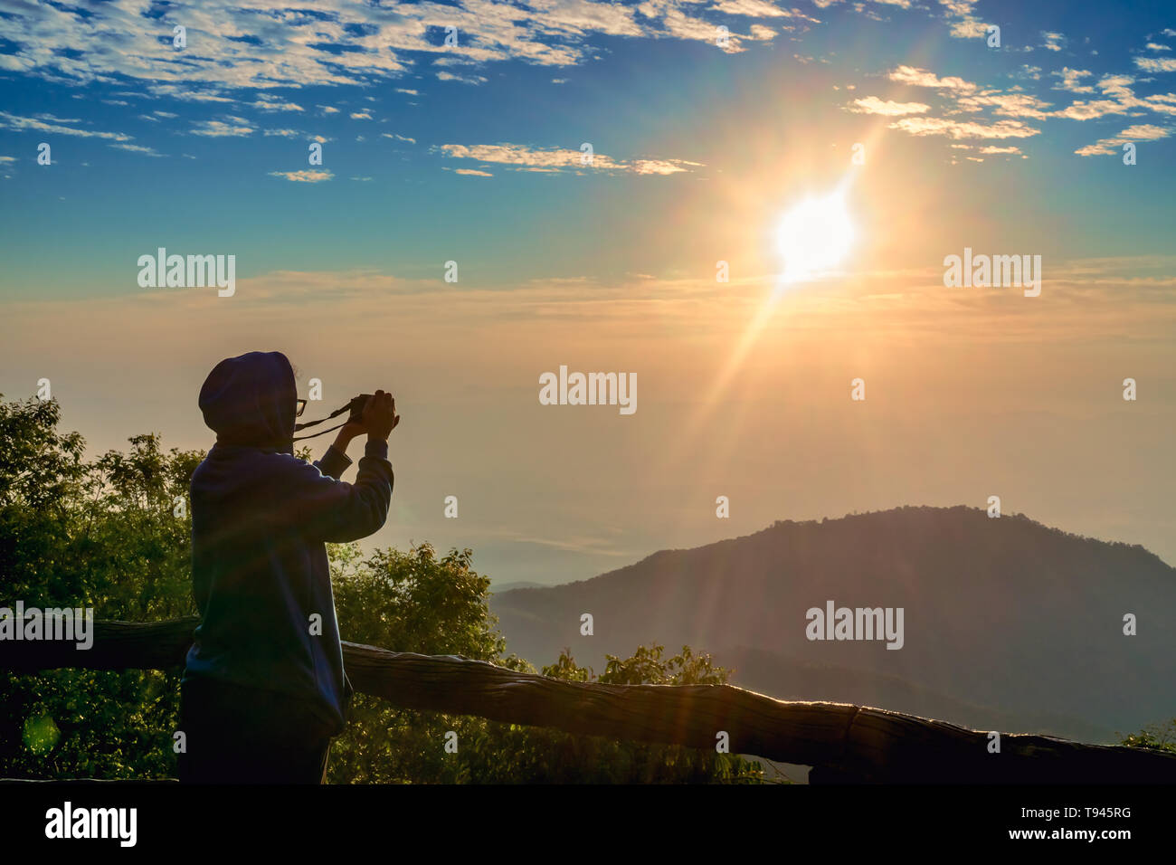 Tourism vacation and travel. A tourist taking photo of beautiful sun ...