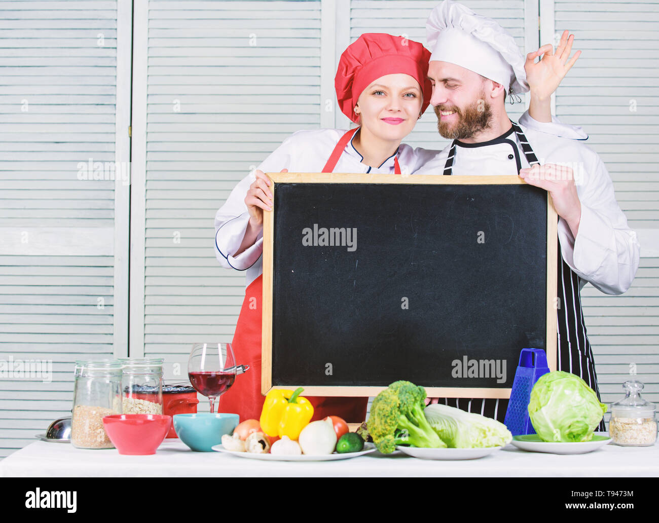 Lets make dinner together. Chef and cook helper gesturing ok sign at ...