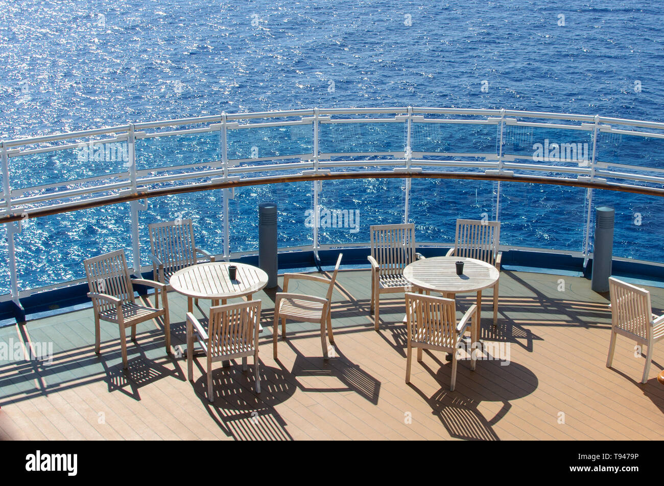 View from the deck of a cruise ship in the ocean. Seating area for ...