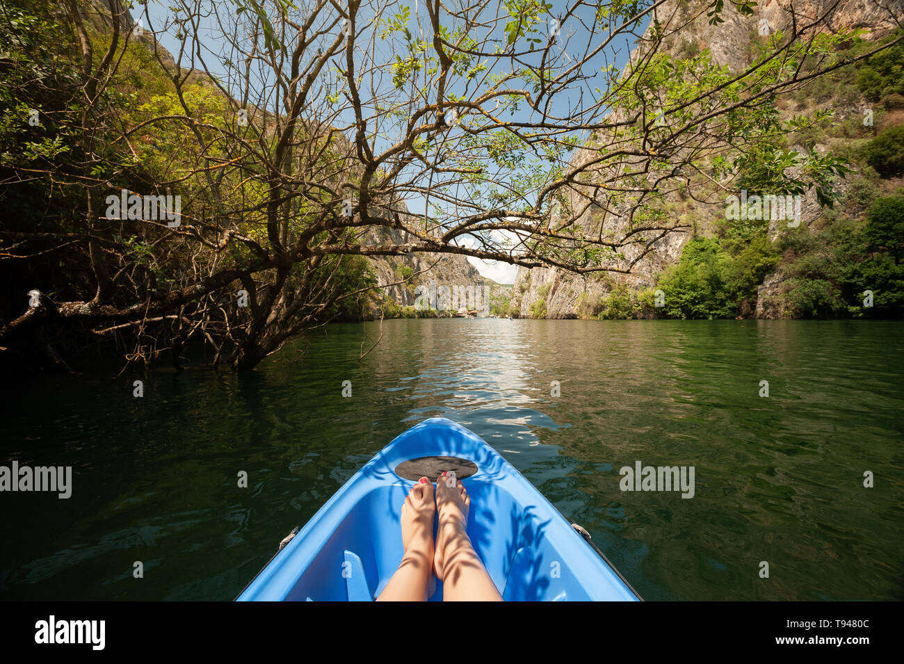 Kayaking through river in Matka canyon, Macedonia. Woman legs in the ...